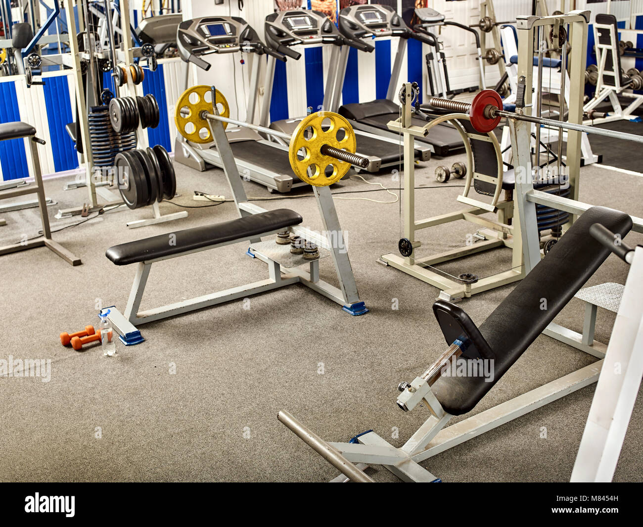 Fitness Room with jogging treadmill and Weight Machines Stock Photo - Alamy
