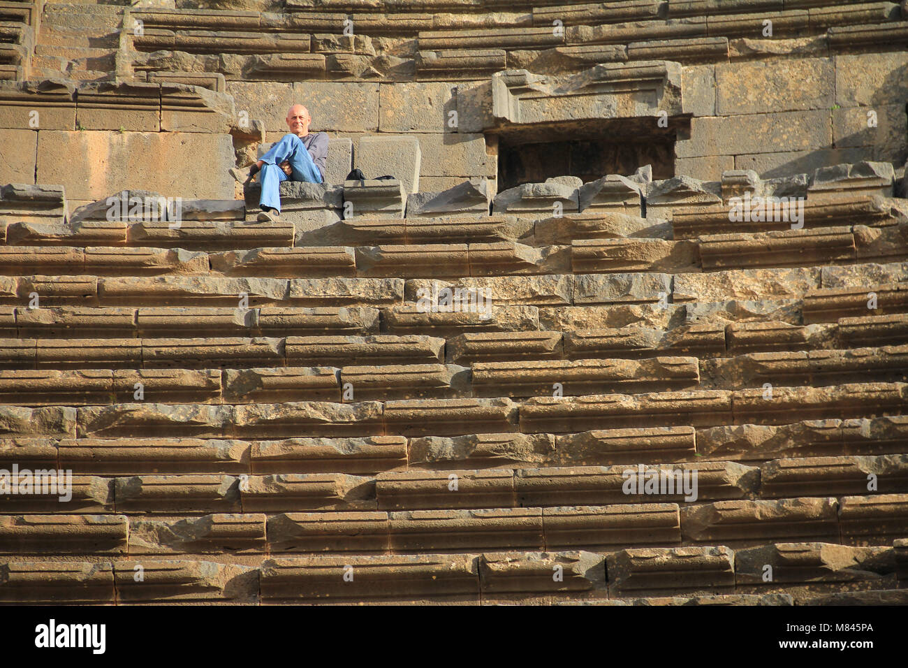Rows of seats and stairway, ancient Roman basalt open amphitheatre ...
