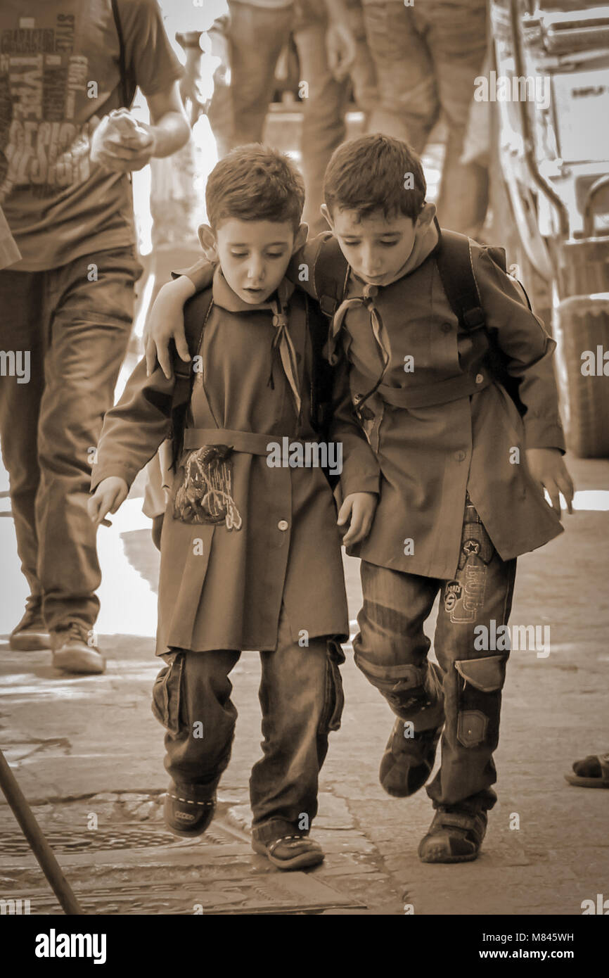 Damascus, Syria - 09.30.2010: Two small syrians in school uniforms go ...