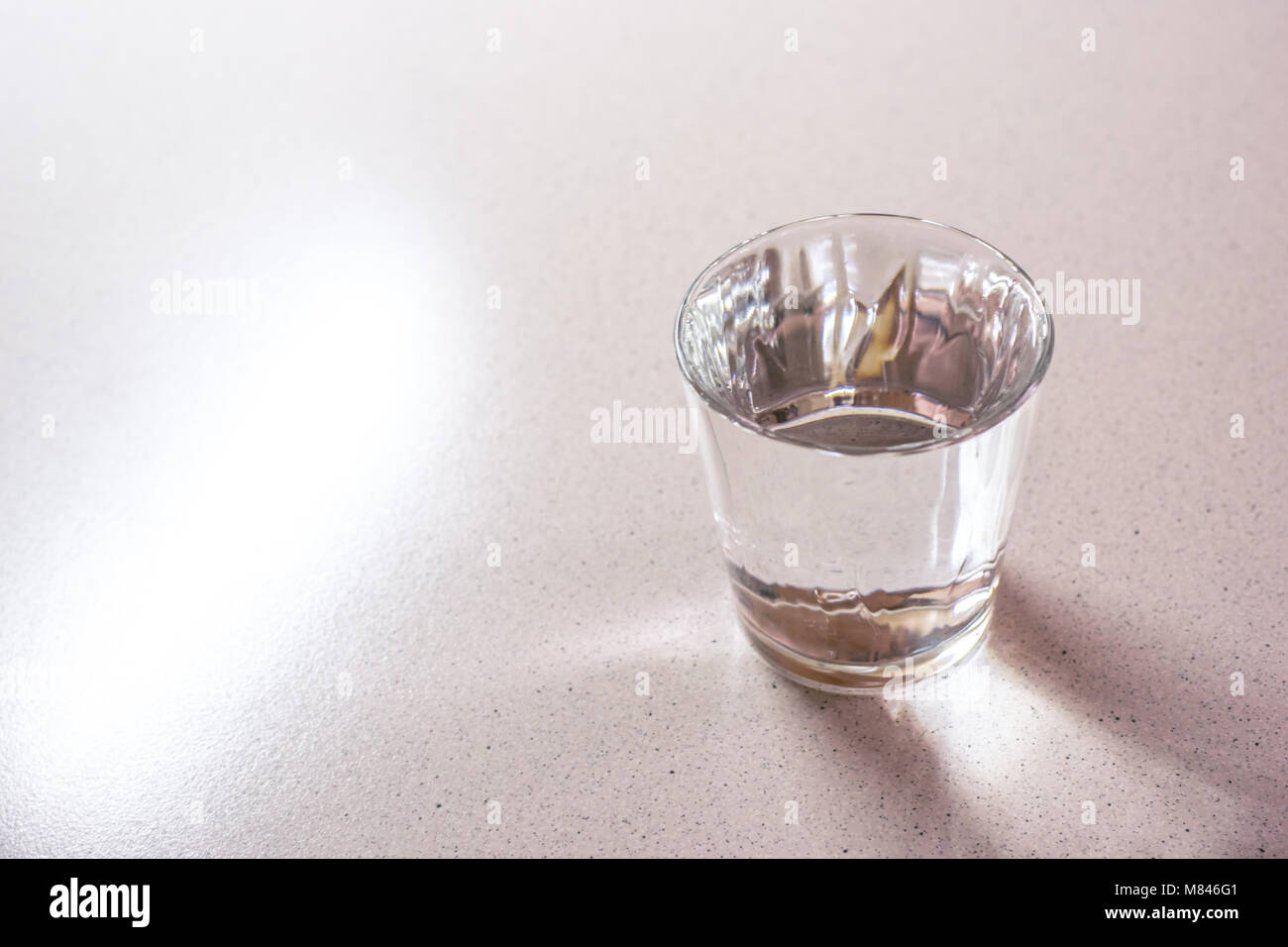 One glass full of water on the table Stock Photo - Alamy