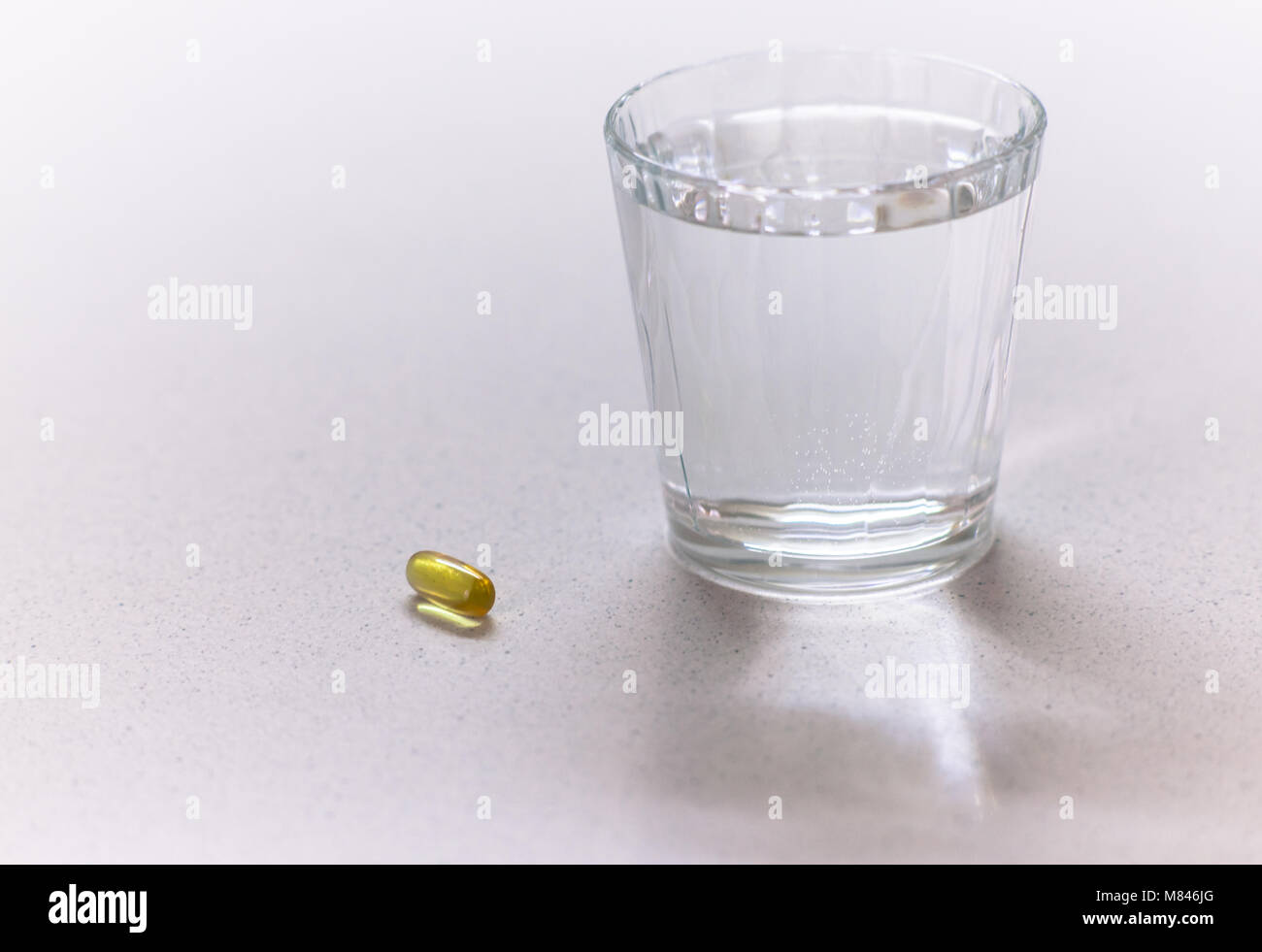 Glass of water and capsule Stock Photo - Alamy