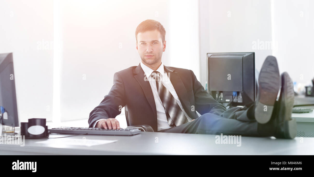 confident businessman sitting at Desk in a private office Stock Photo ...