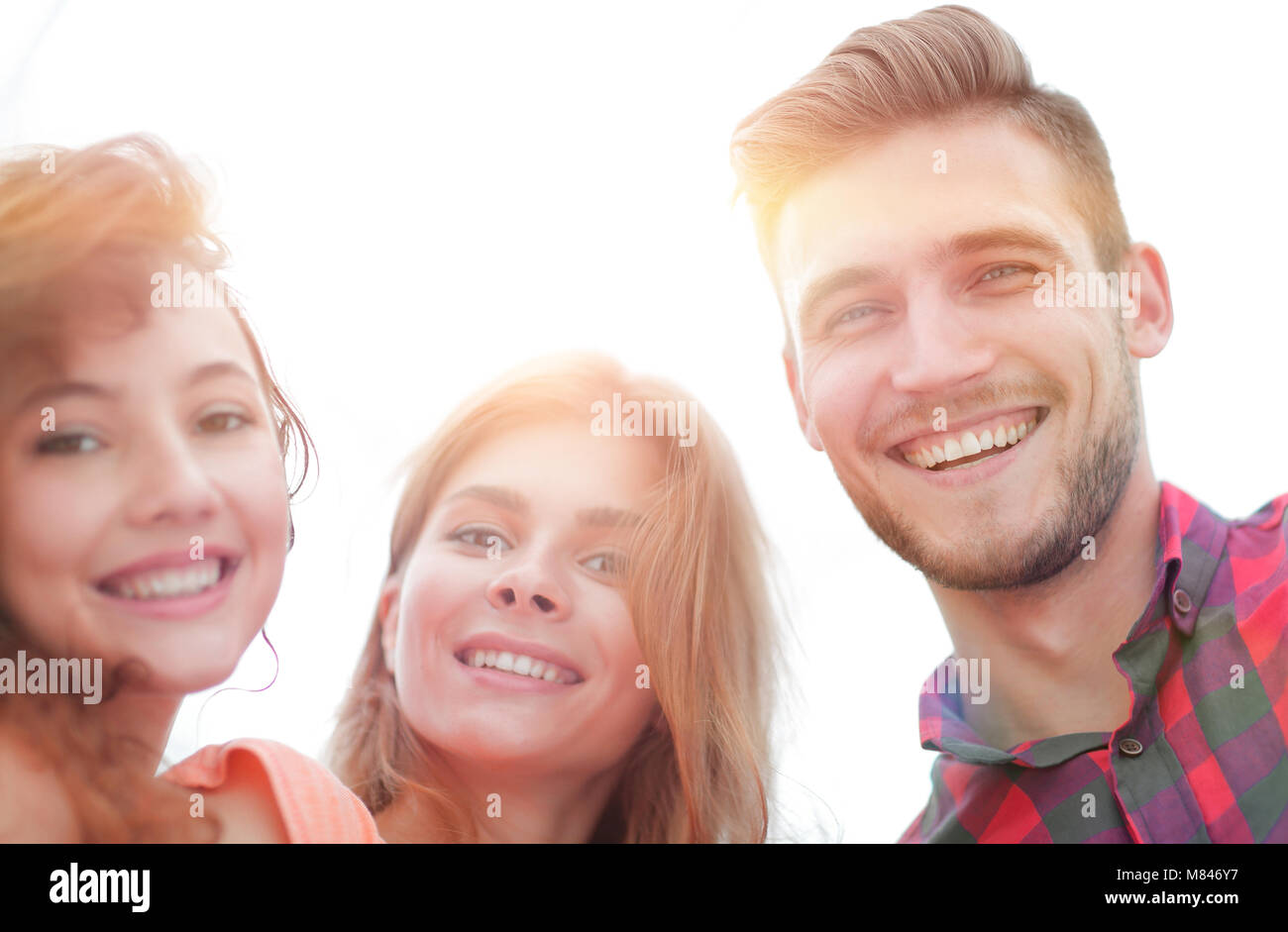 closeup of three young people smiling on white background Stock Photo ...