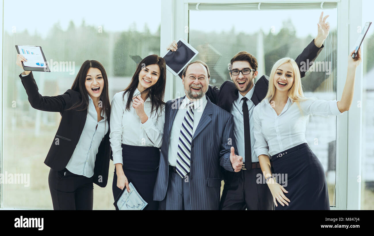 boss and happy business team rejoice after signing a lucrative ...