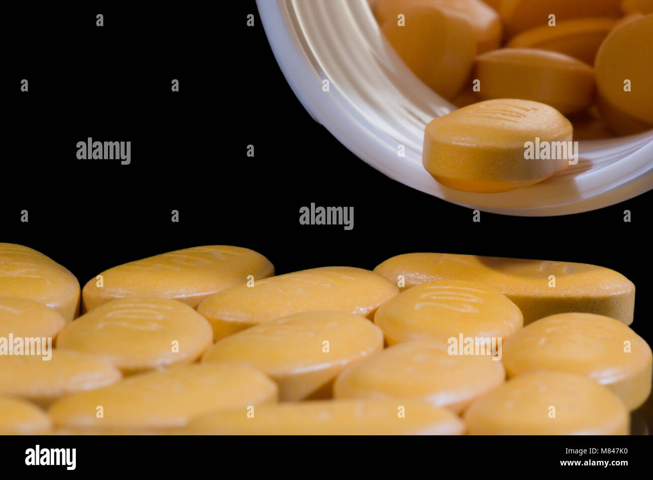 Medication pills isolated on a black background Stock Photo - Alamy