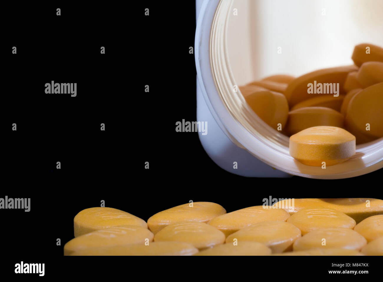 Medication pills isolated on a black background Stock Photo - Alamy