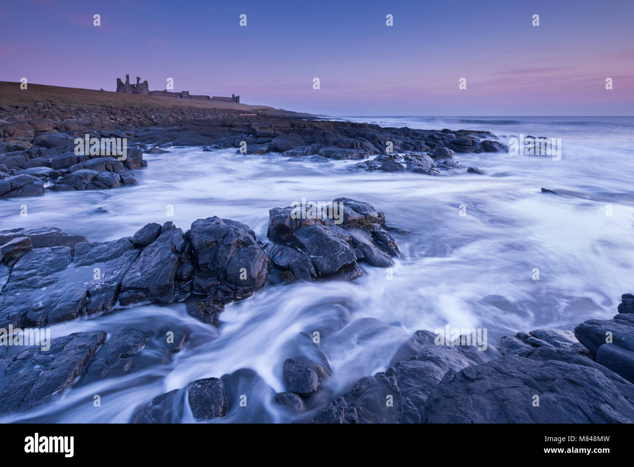 Dunstanburgh Castle at dawn, Craster, Northumberland, England. Spring ...