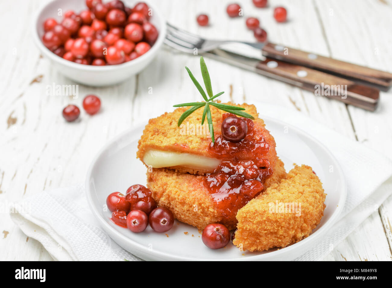 Baked breaded Camembert cheese (brie) with fresh berries and cranberry ...
