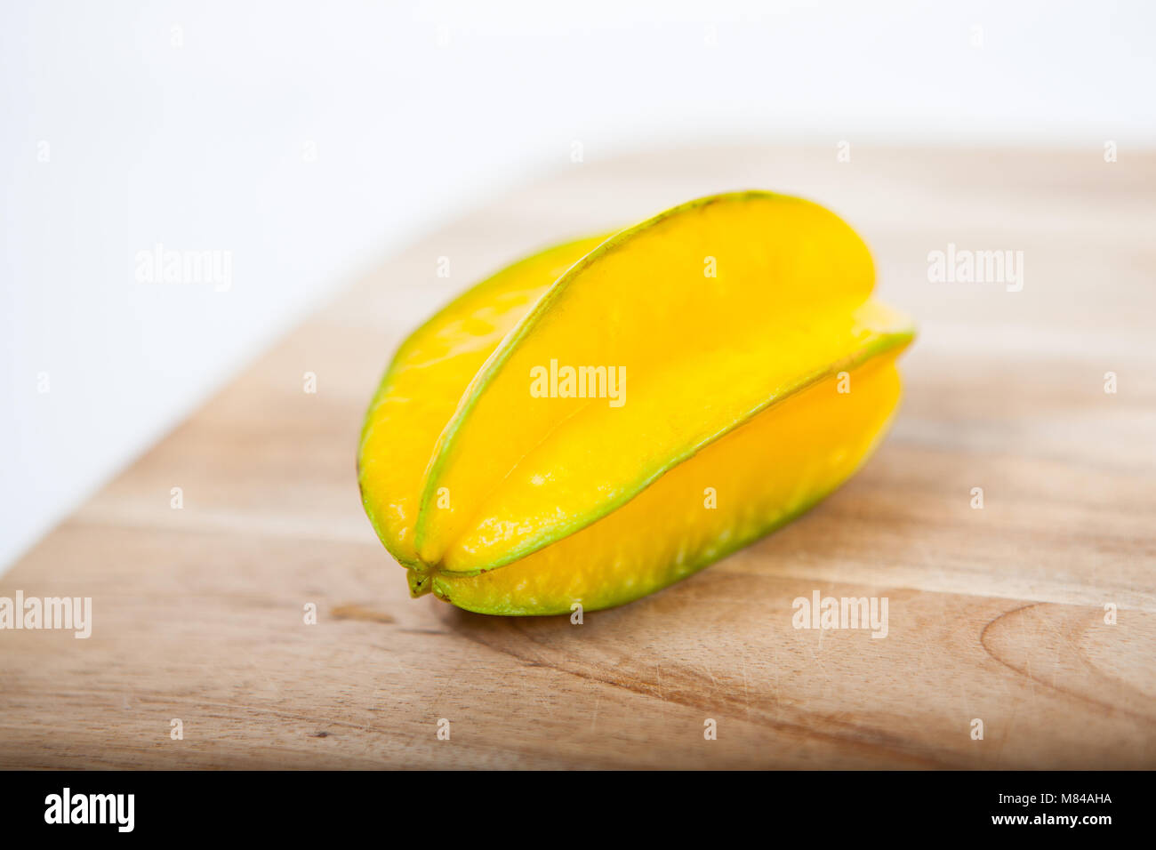 Exotic starfruit or averrhoa carambola on wooden cut board Stock Photo ...