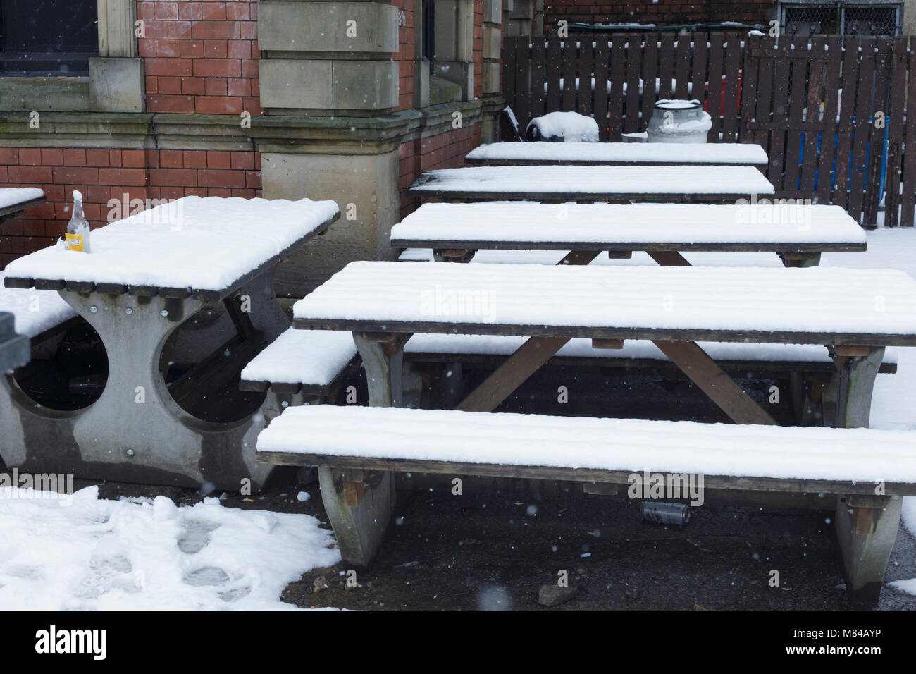 Snow covered benches outside 'The Library' pub, Woodhouse, Leeds ...