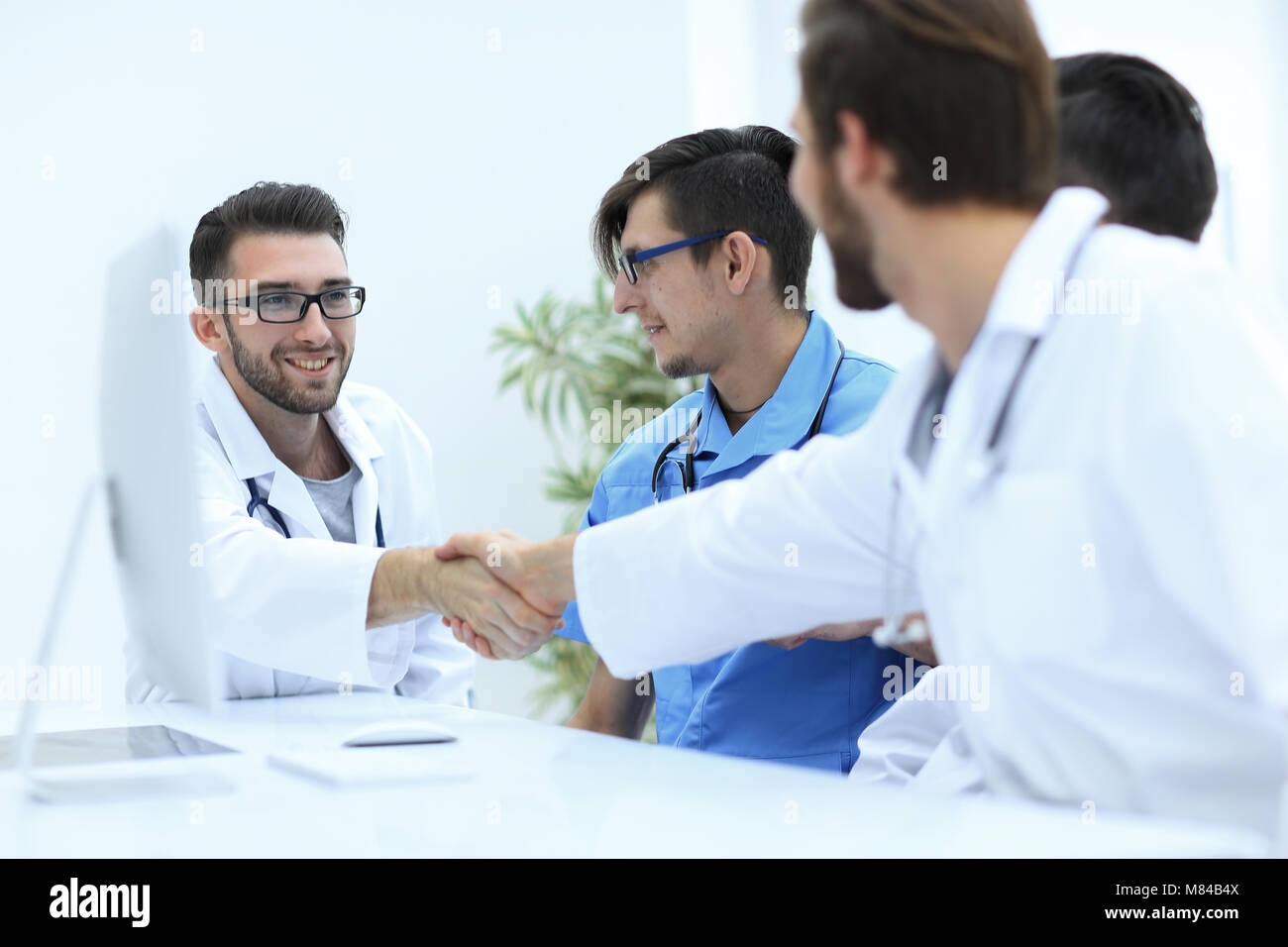 handshake between the two doctors during the working meeting Stock ...