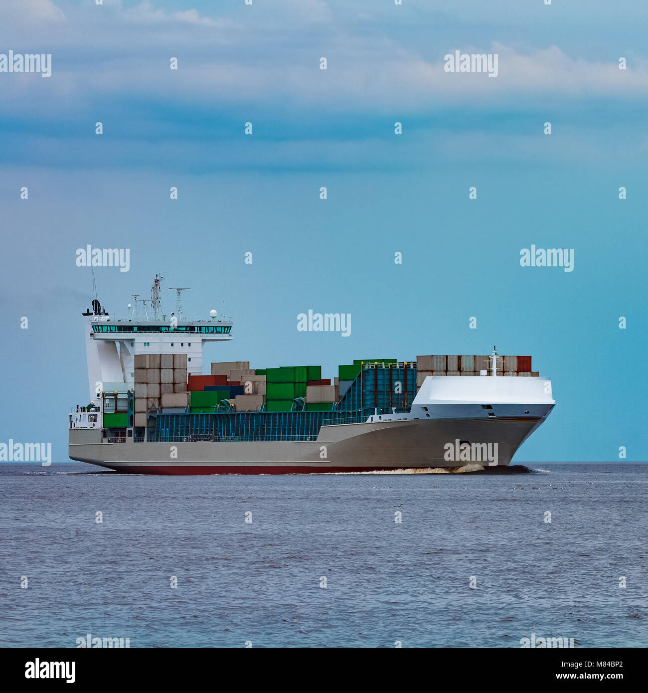 Grey container ship. Logistics and production import Stock Photo - Alamy