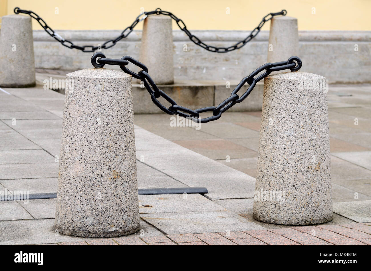 Granite posts with chains.The aesthetic embellishment on the street ...