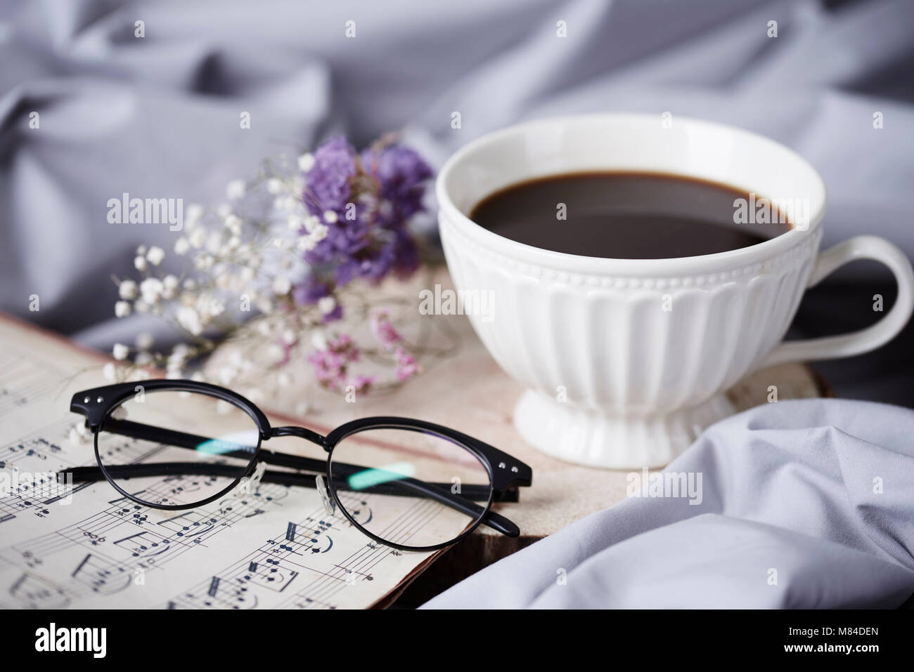 Shot of black coffee and music note on bed Stock Photo - Alamy