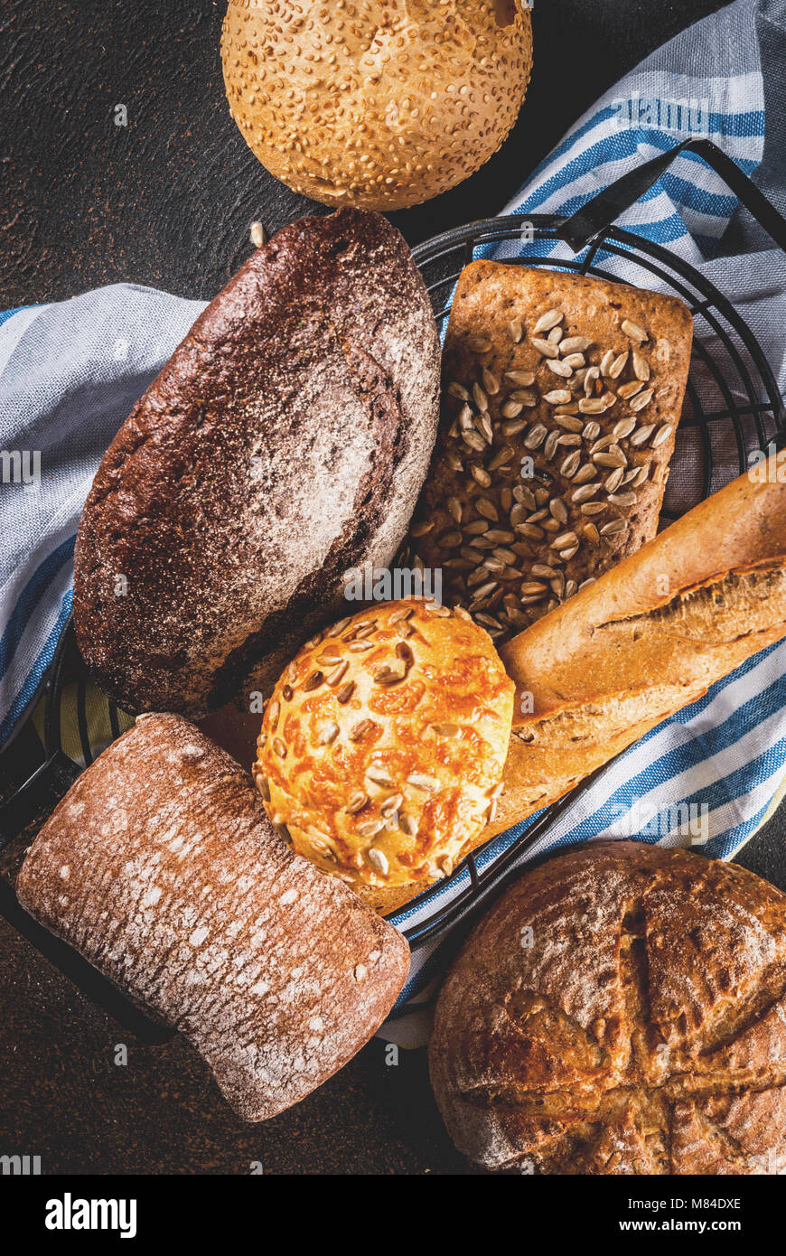 Variety of fresh homemade grain bread, in a metal basket, dark rusty ...