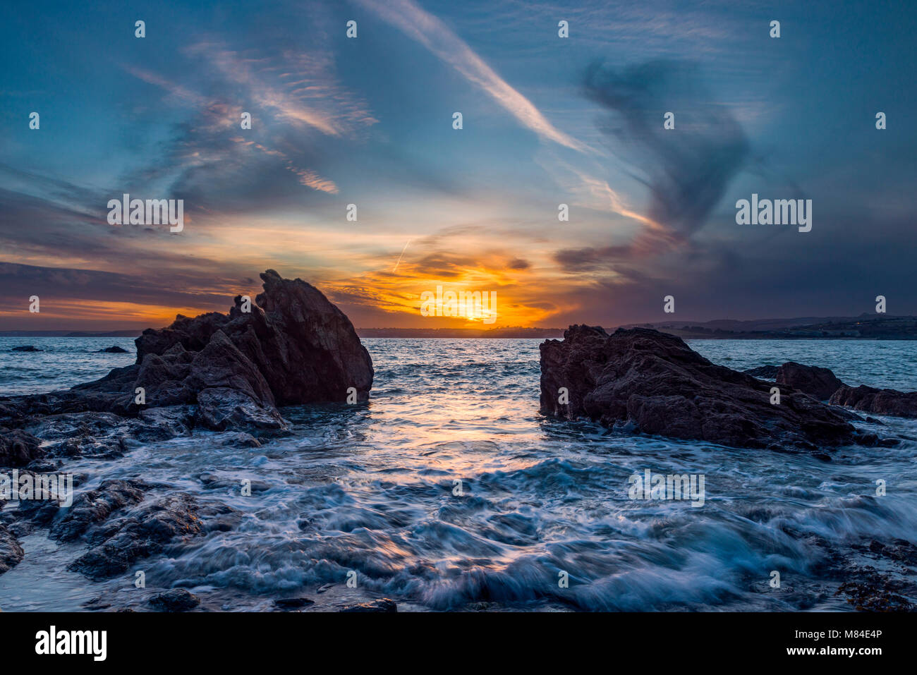 A deep purple sunset framed between two ancient volcanic rocks at ...