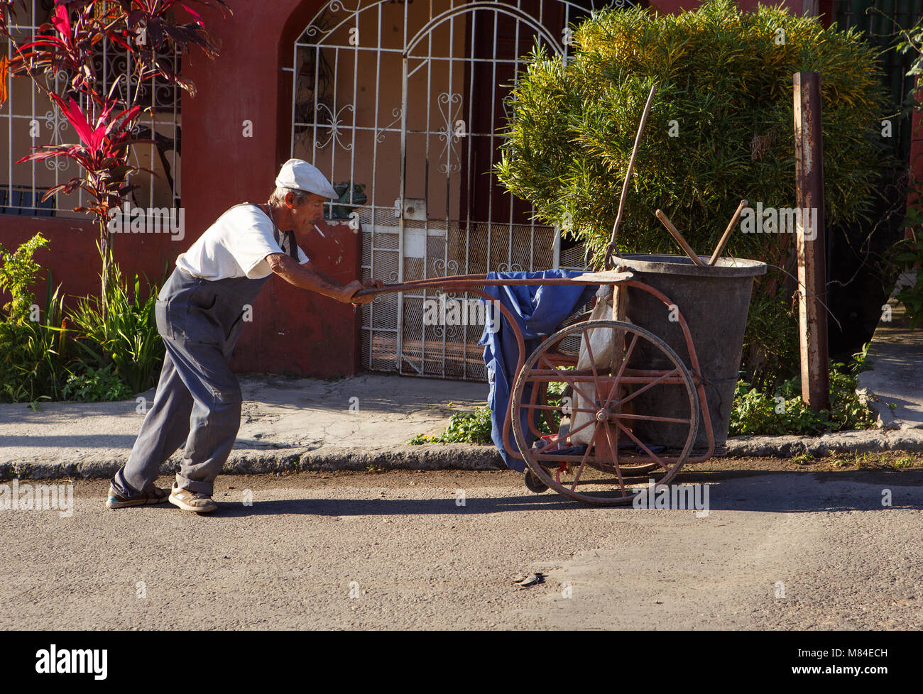 Man cleaning trash bin hi-res stock photography and images - Alamy
