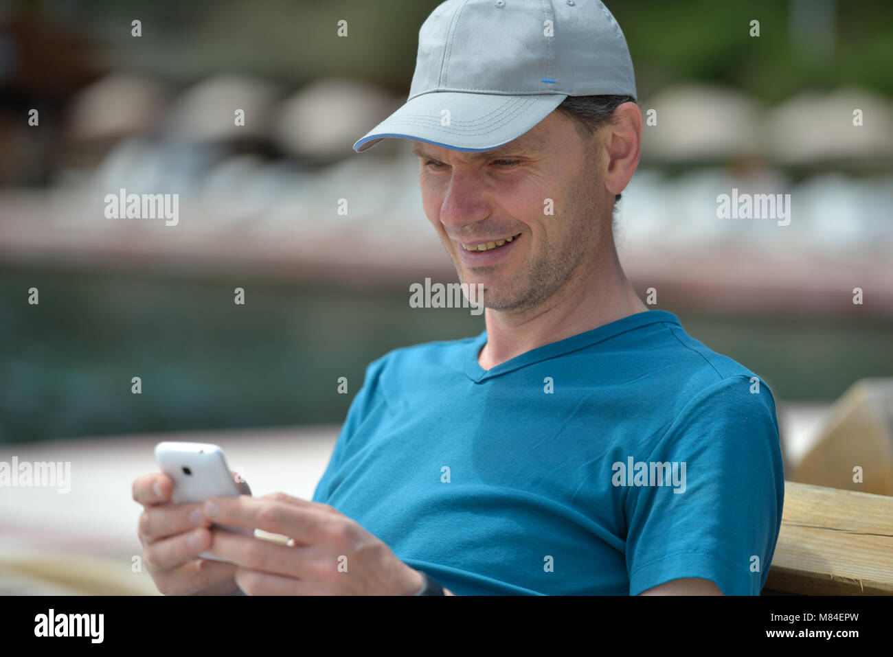 Man with smartphone on a beach Stock Photo - Alamy