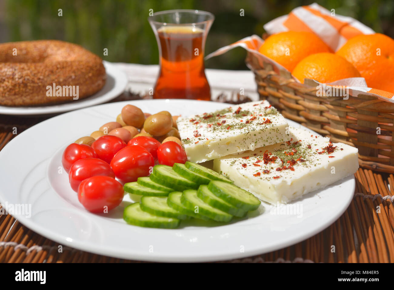 Turkish breakfast with cheese, vegetables, simit, and tea Stock Photo ...