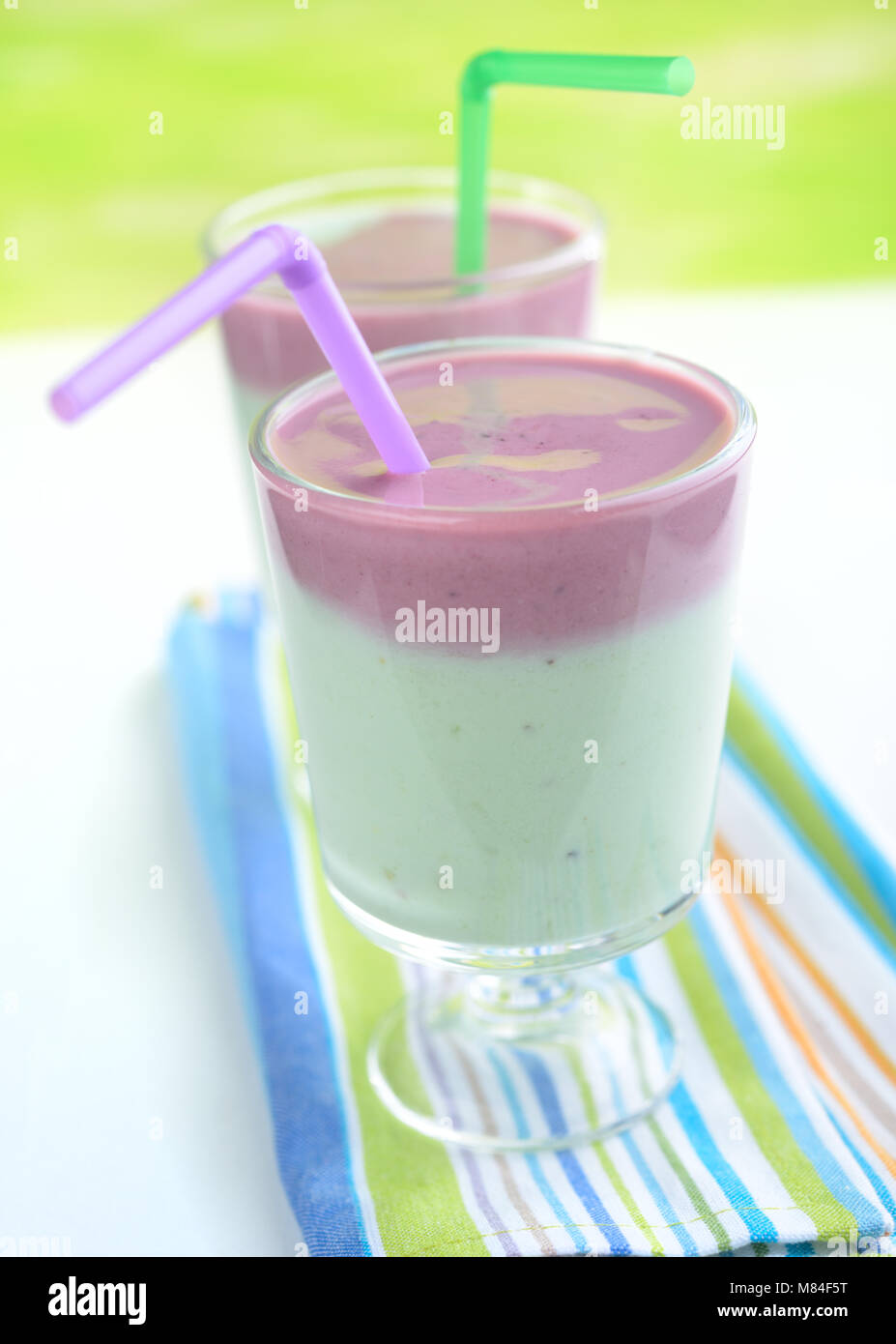 Fruit yogurt in a glass with cocktail straw Stock Photo - Alamy