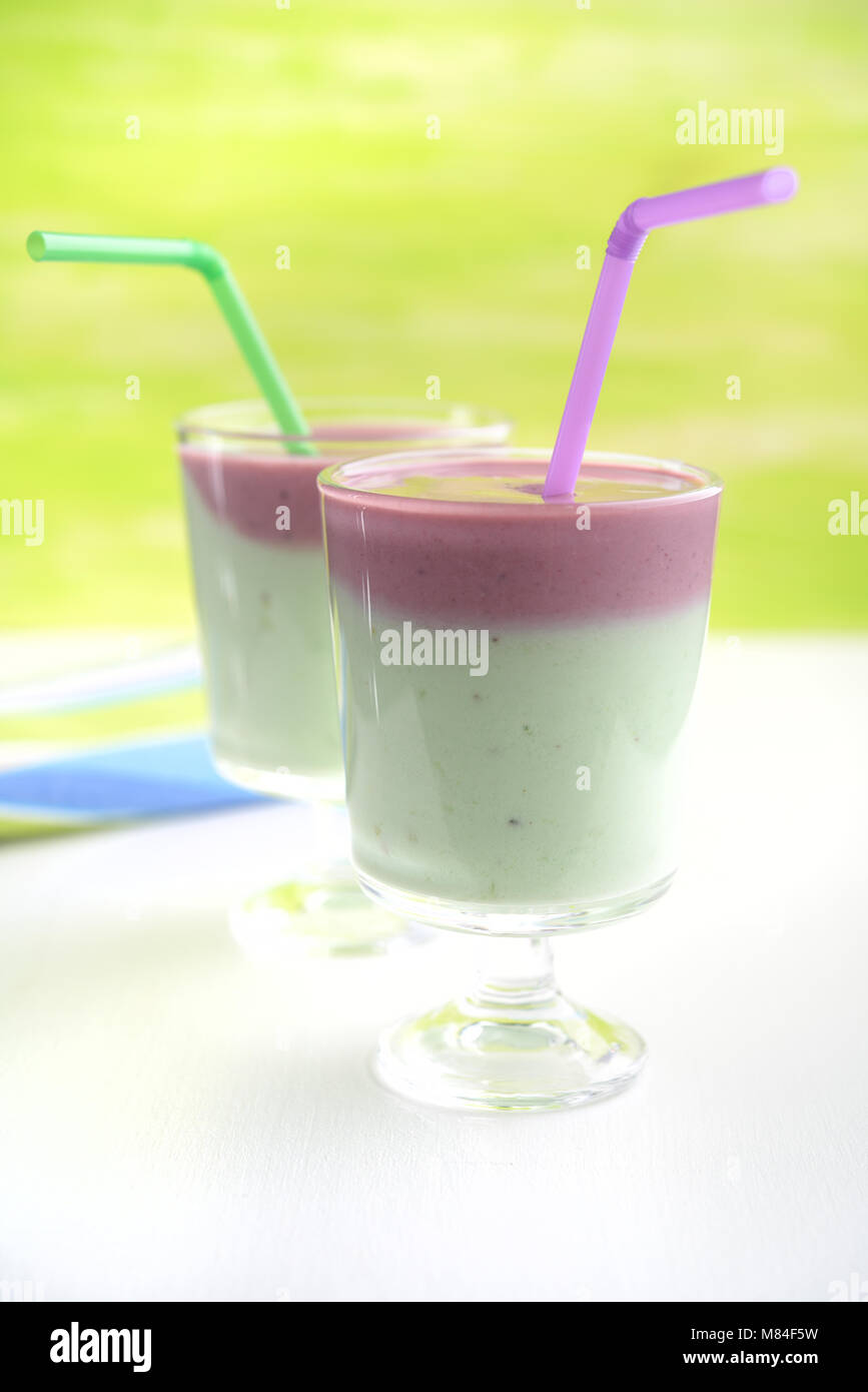 Fruit yogurt in a glass with cocktail straw Stock Photo - Alamy