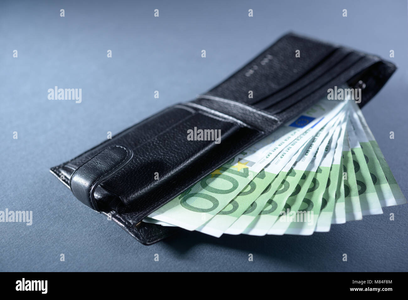 Wallet with Euro banknotes on a table Stock Photo - Alamy
