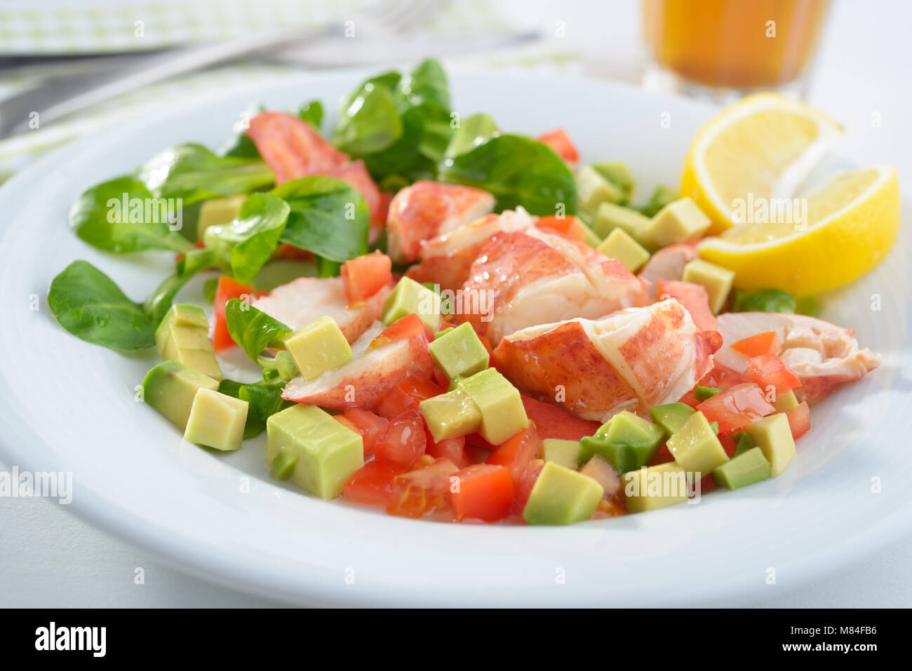 Lobster salad with avocado, tomato, lettuce, and lemon Stock Photo - Alamy