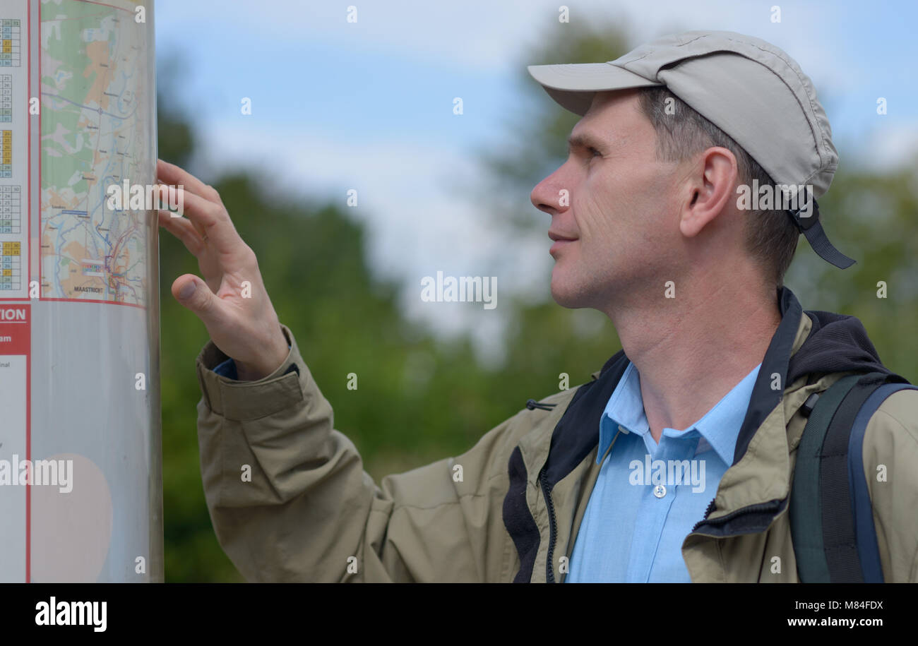 Man reading the timetable on a bus stop in Netherlands Stock Photo - Alamy