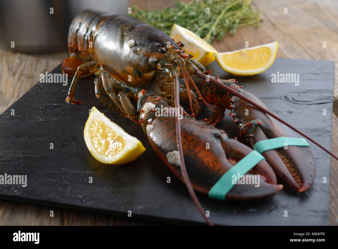 Clawed lobster on a table before cooking Stock Photo - Alamy