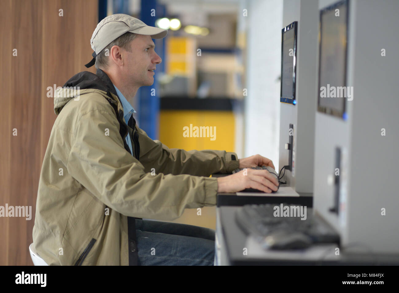 Man using public internet access point in airport Stock Photo - Alamy
