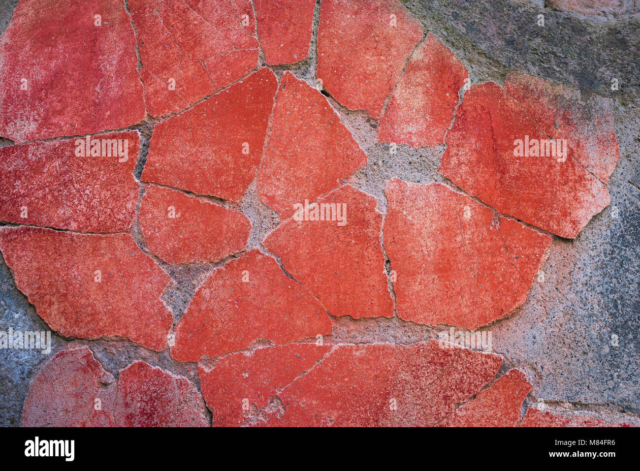 Roman wall, fragments of ancient red plaster adhering to a wall in an ...