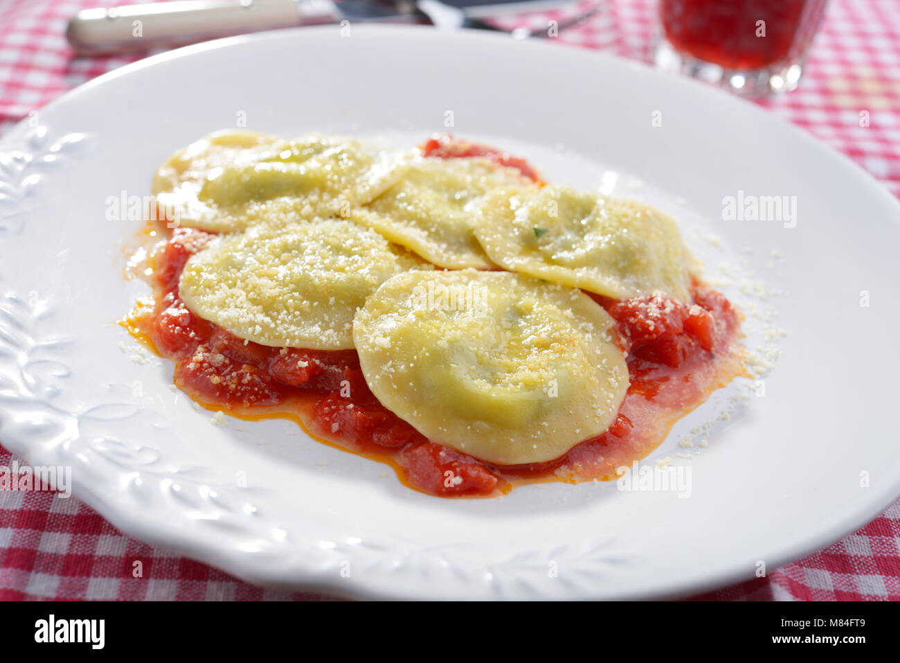 Spinach and ricotta ravioli with tomato and grated Parmesan Stock Photo ...