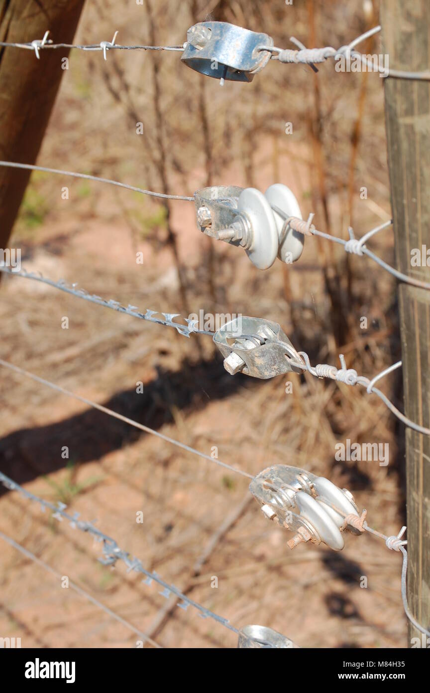 Barbed wire electric fence / border Stock Photo - Alamy