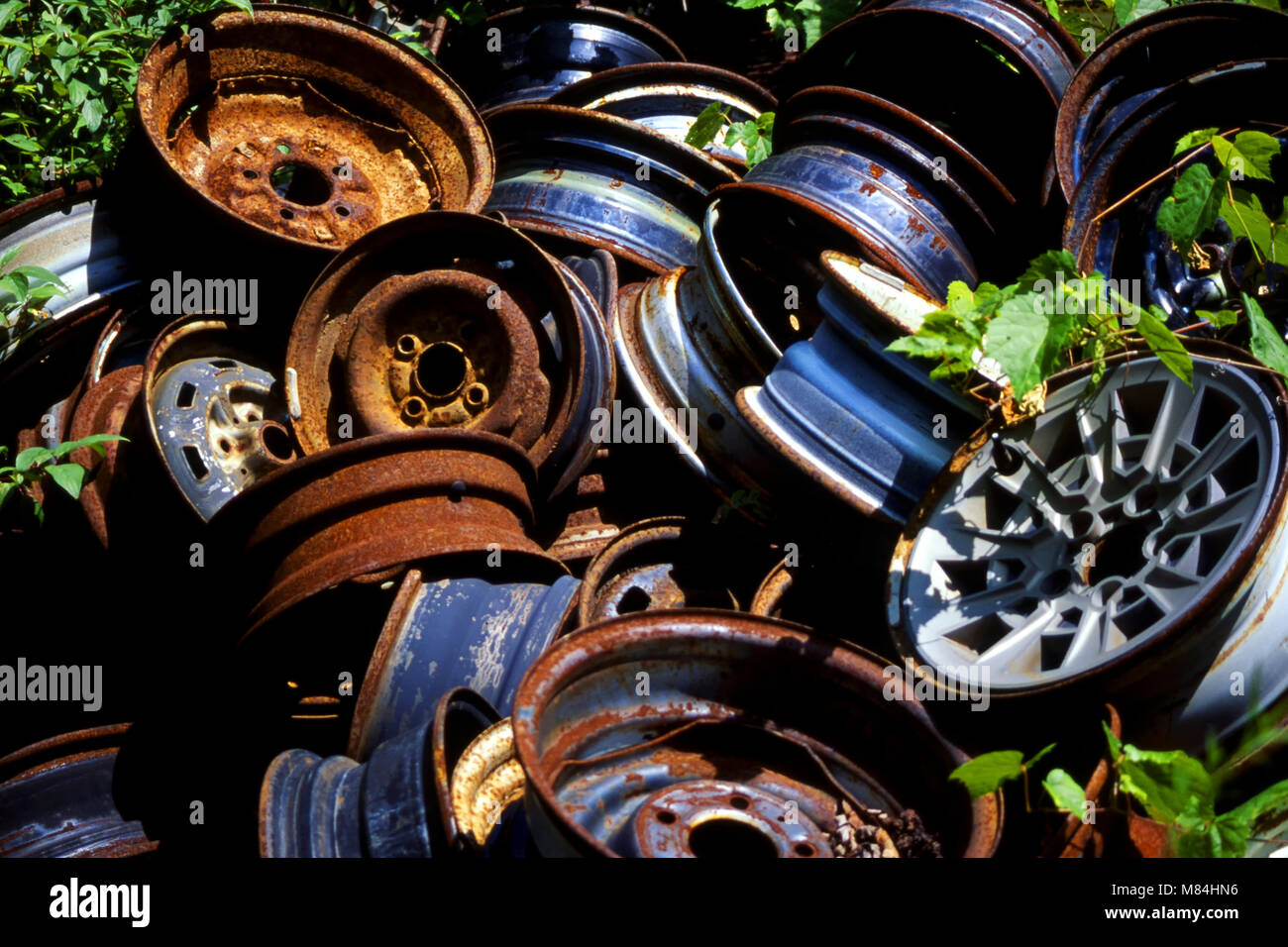 Wheel rims in pile at junkyard Stock Photo - Alamy