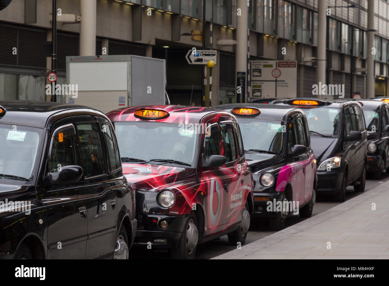 Parked London black cab taxis awaiting a fare near Kings Cross Station ...