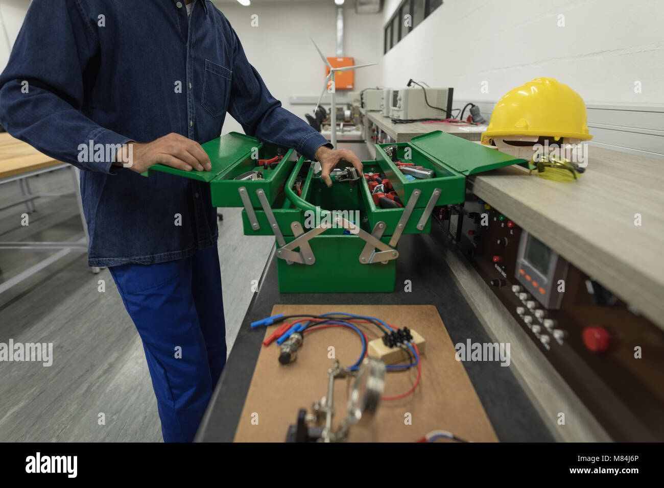 Male worker removing tools from toolbox Stock Photo - Alamy