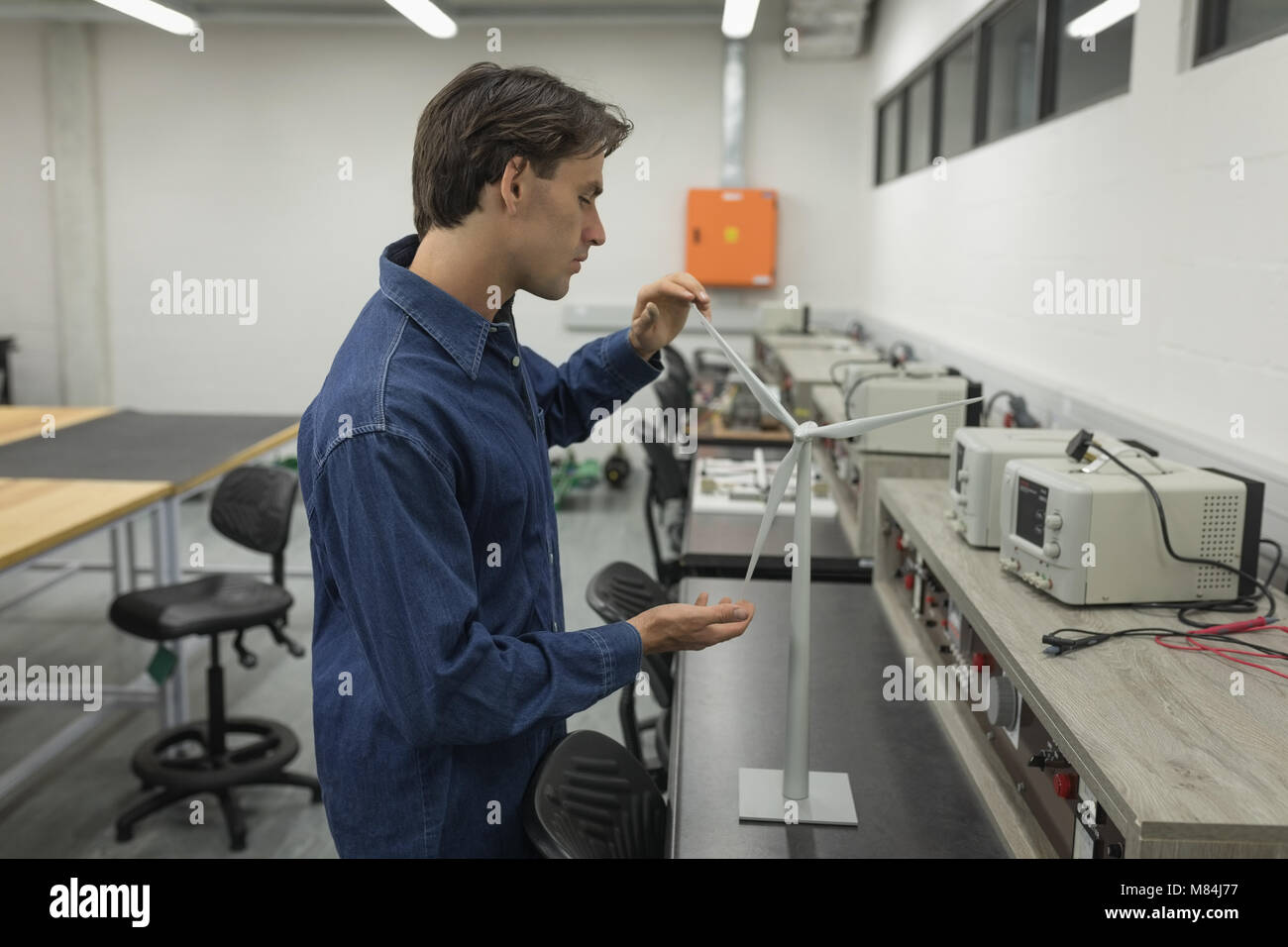Male worker working on windmill Stock Photo - Alamy