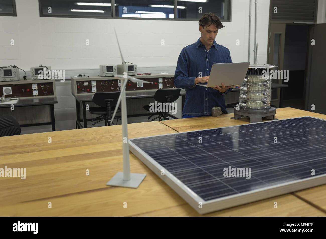 Male worker using laptop in office Stock Photo - Alamy