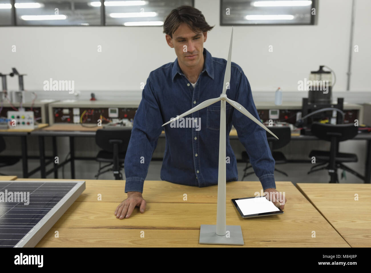 Male worker working on windmill Stock Photo - Alamy