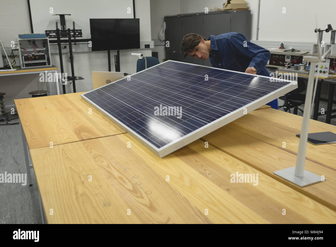 Male worker working on solar panel Stock Photo - Alamy