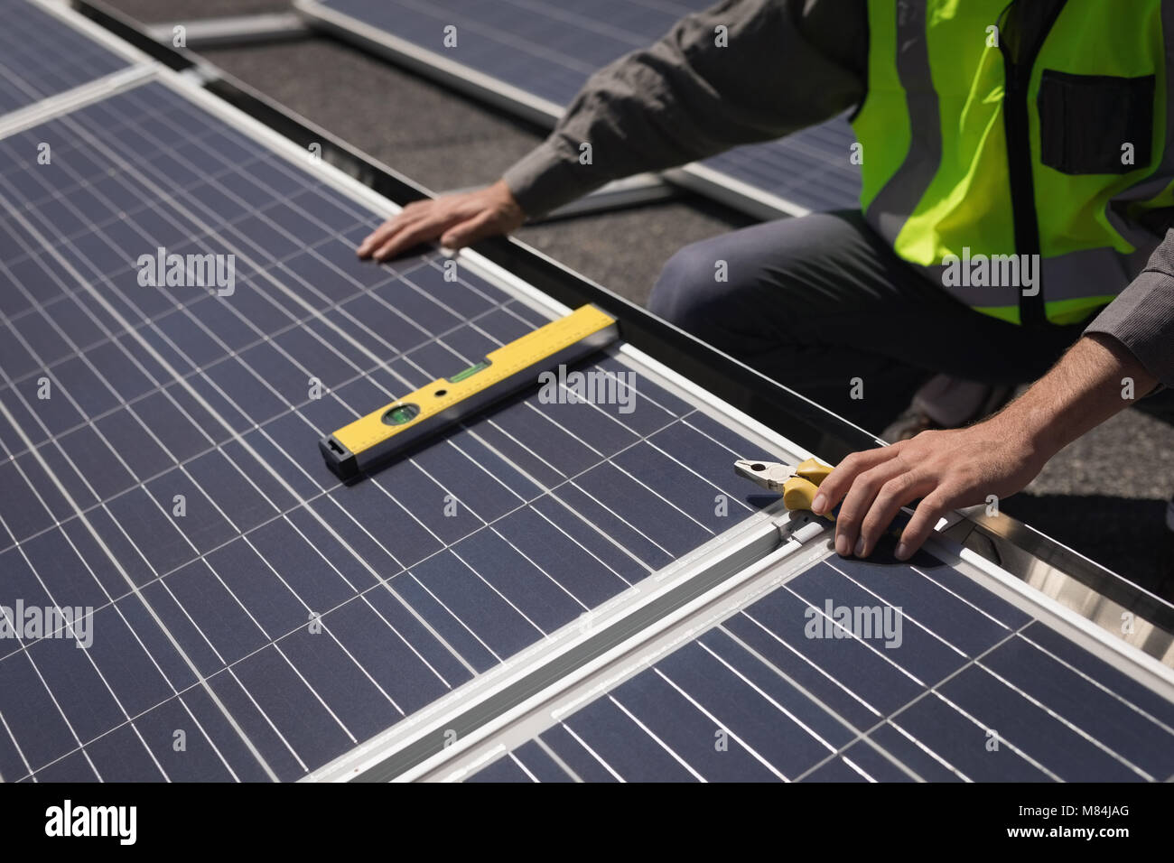 Male worker working on solar panels at solar station Stock Photo - Alamy