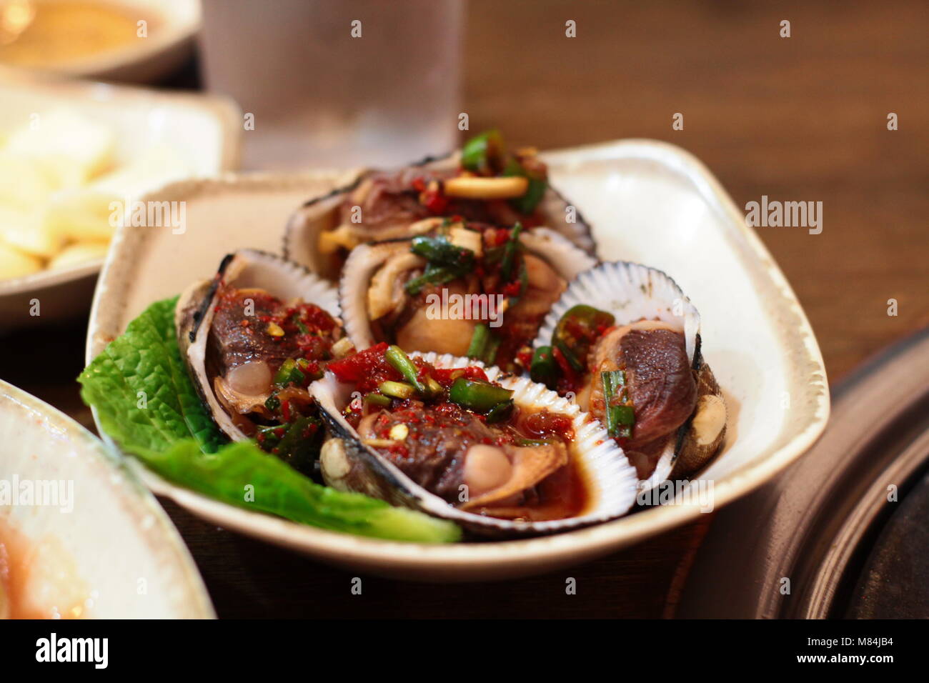Korean cuisine, side dishes - Marinated blood cockle Stock Photo - Alamy
