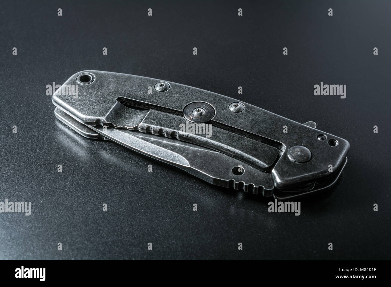 Handle Of A Closed Black Folding Knife Lying On Dark Ground With ...