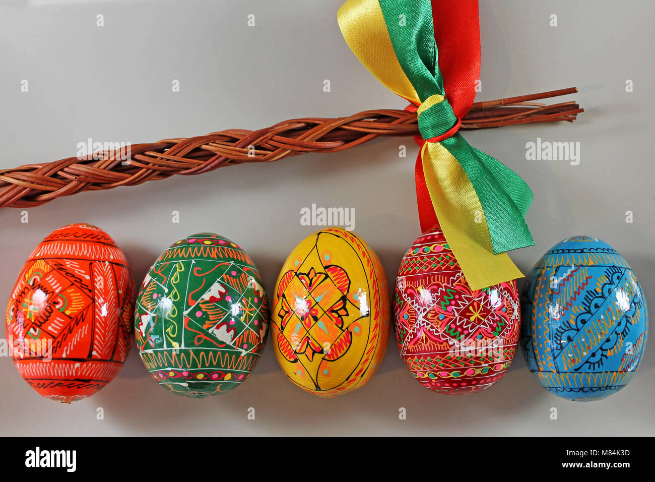 Traditional czech Wicker whip and easter eggs in row. Traditional Czech ...