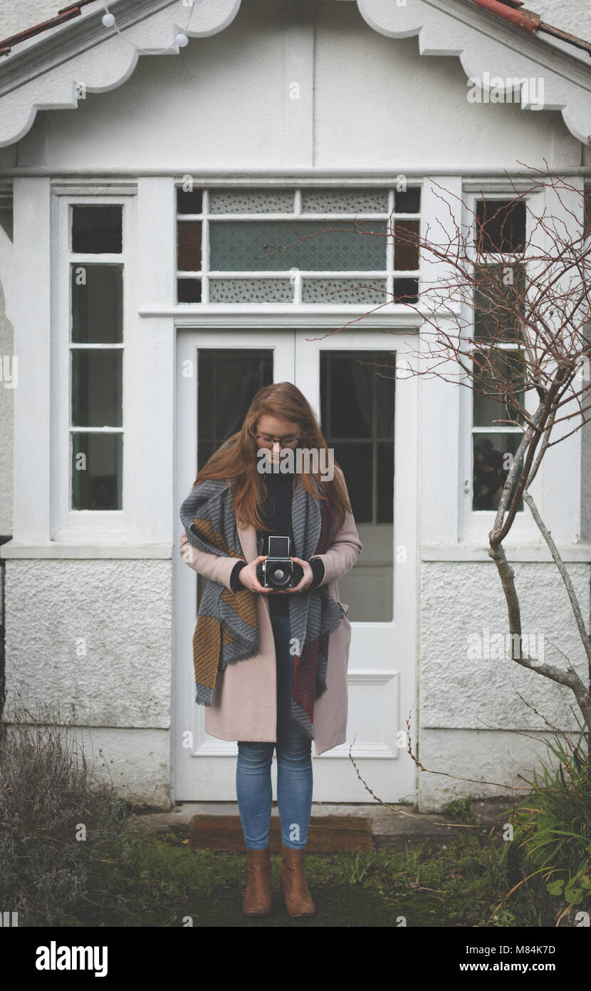 Woman taking photo with vintage camera in the backyard Stock Photo - Alamy