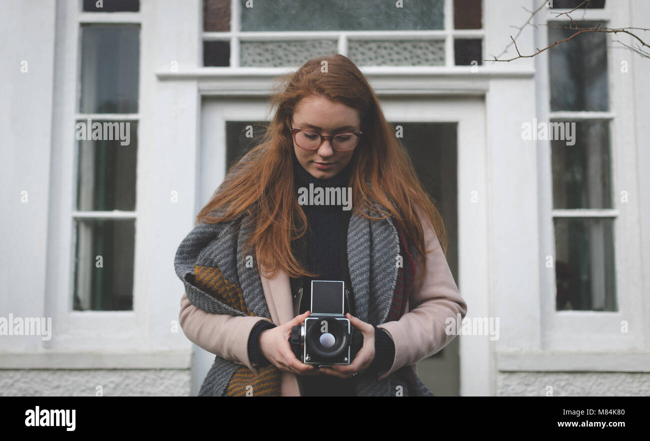 Woman taking photo with vintage camera in the backyard Stock Photo - Alamy