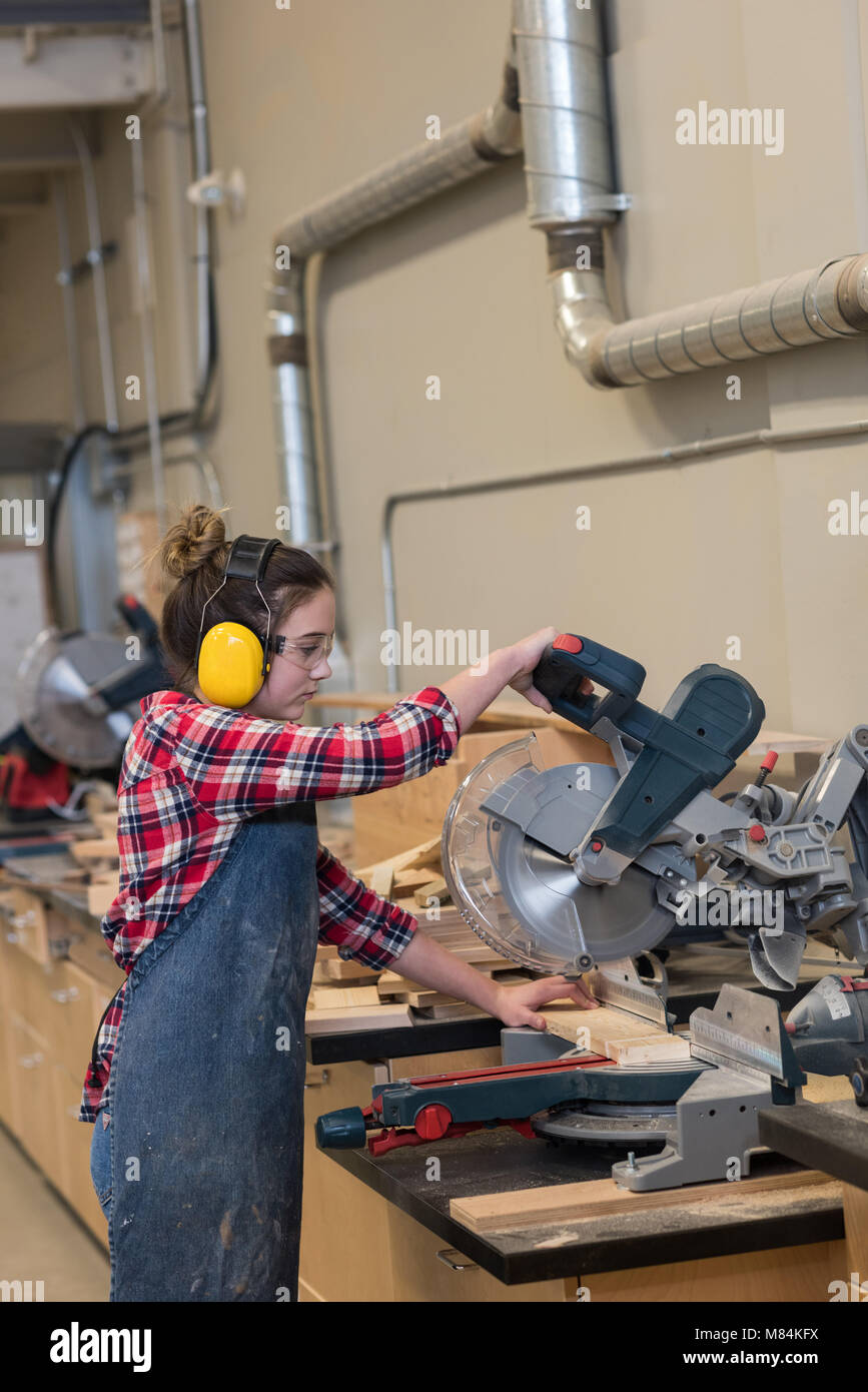 Female carpenter using grinder cutting machine Stock Photo - Alamy