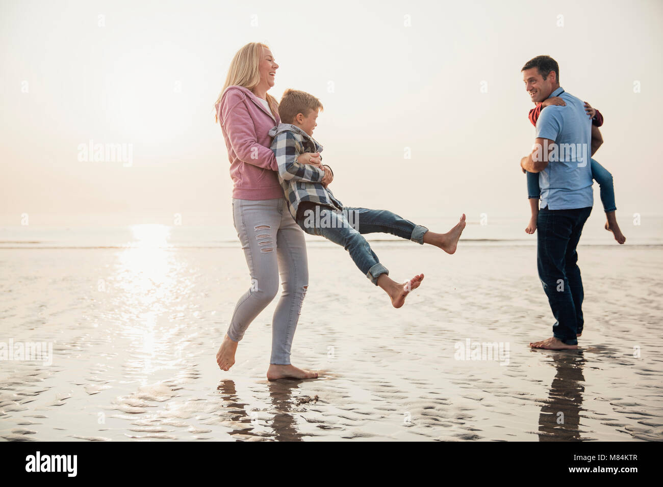 Family having fun and making memories at the beach Stock Photo - Alamy