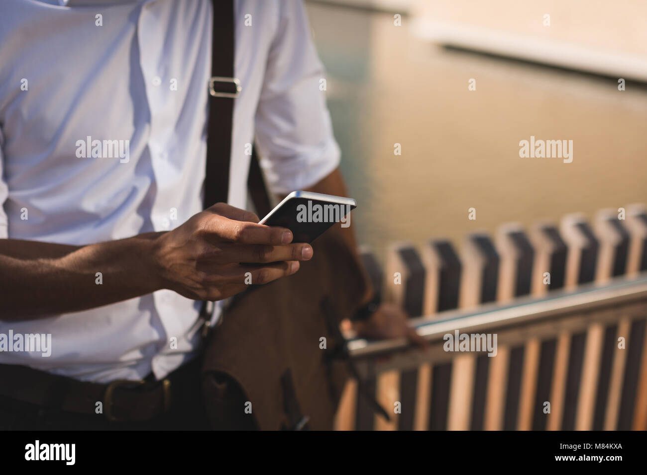 Businessman using mobile phone outside 4k Stock Photo - Alamy