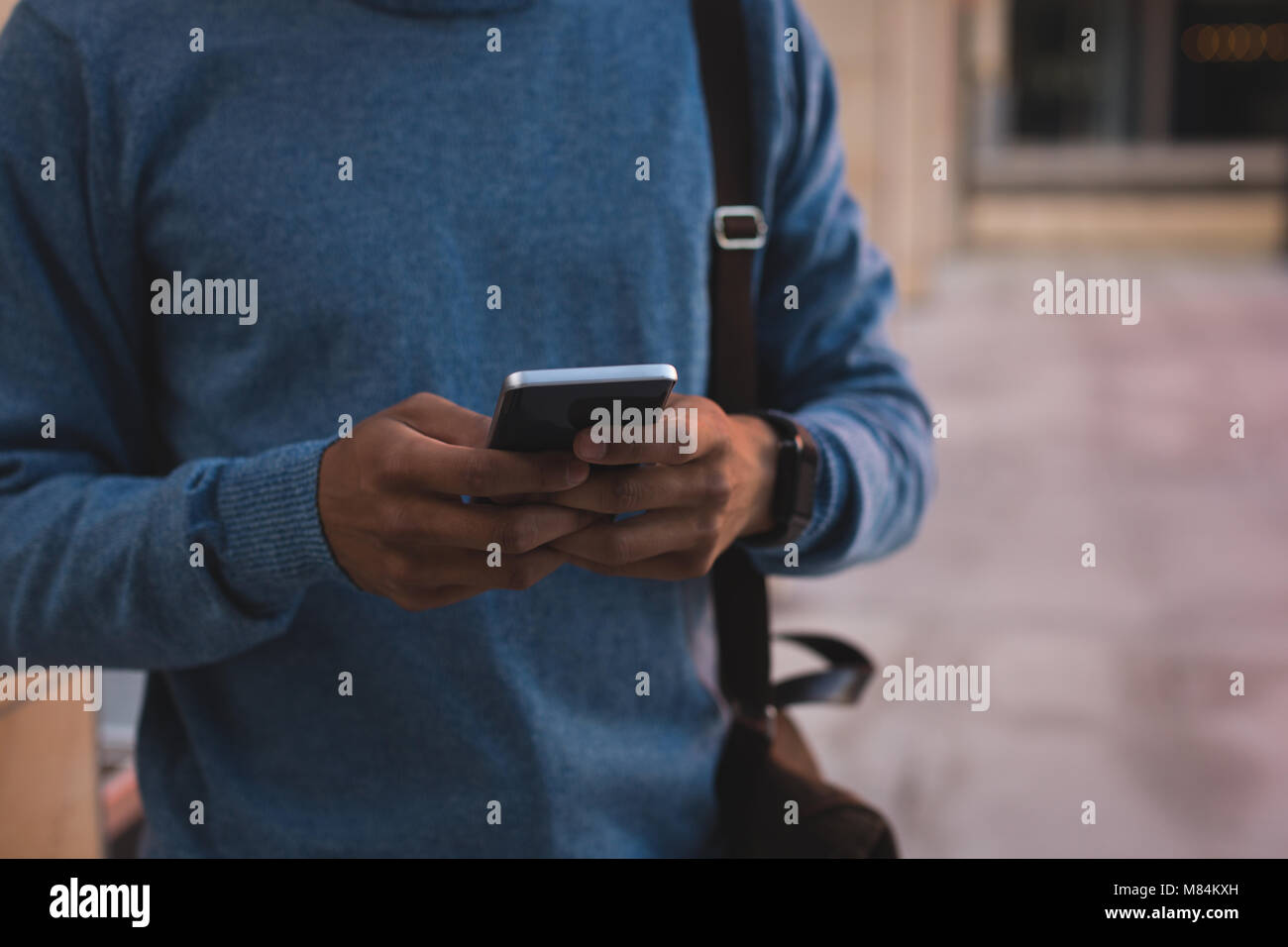Businessman using mobile phone outside 4k Stock Photo - Alamy